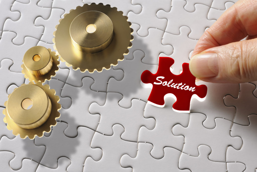 Holding a last red solution puzzle piece with floating gears - Young ...